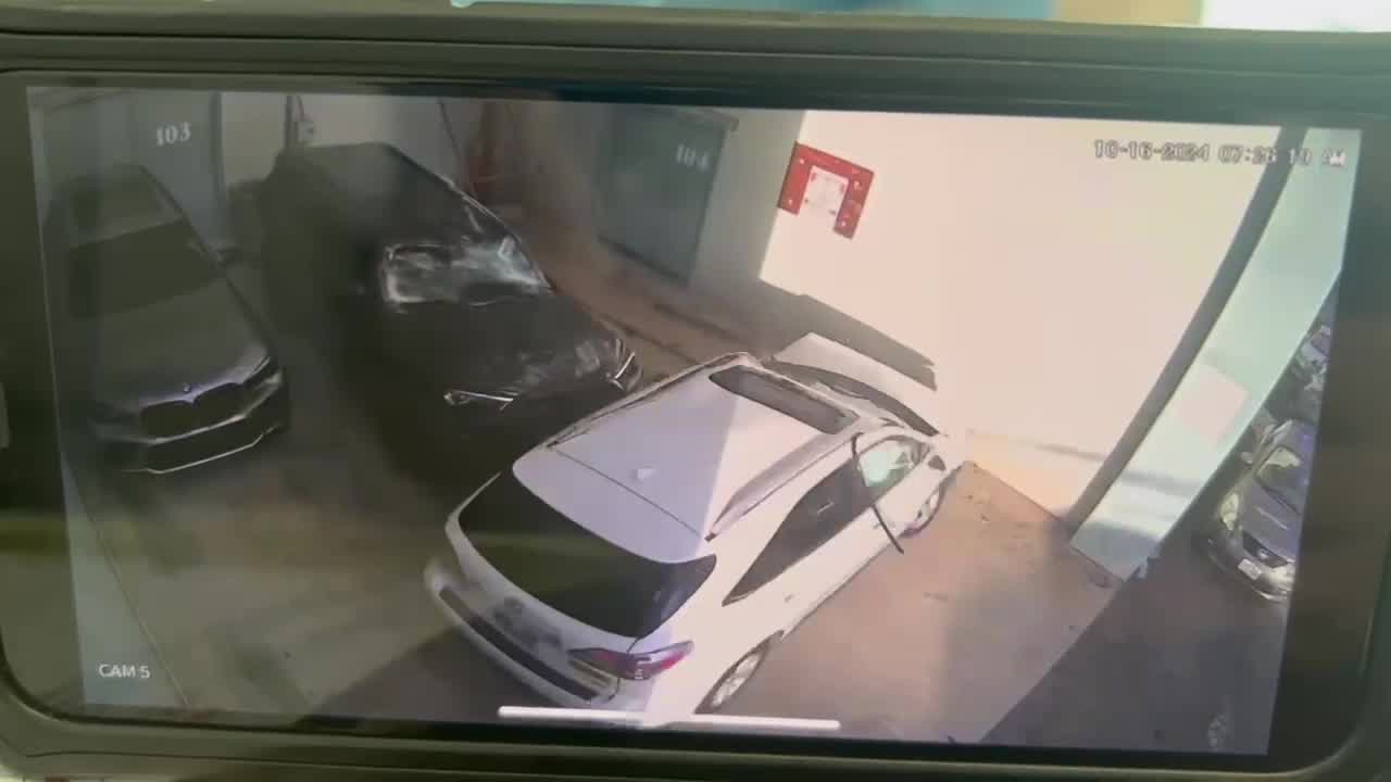 Surveillance video shows woman drive car off parking garage, land on ...